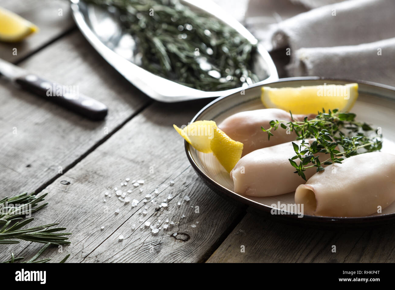 Preparation of raw squid and ingredients on the table Stock Photo - Alamy