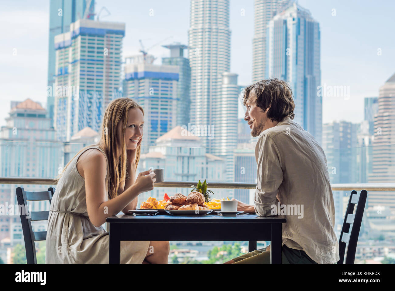 Loving couple having breakfast on the balcony. Breakfast table with ...