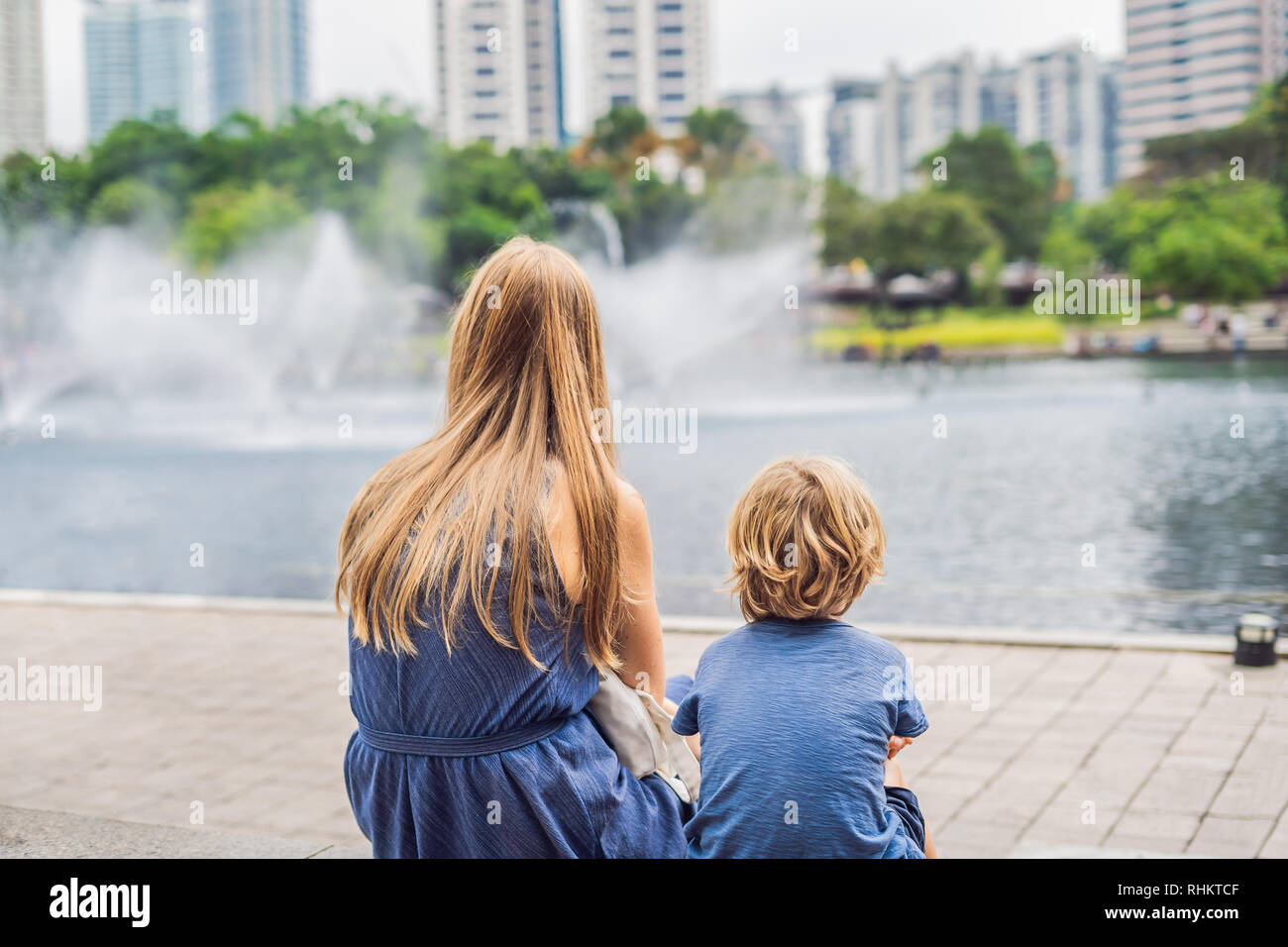 Happy mom with little son enjoying water fountains Stock Photo - Alamy