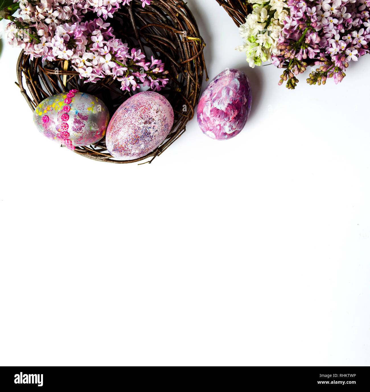 Easter eggs and colorful lilac flowers arrangement Stock Photo - Alamy