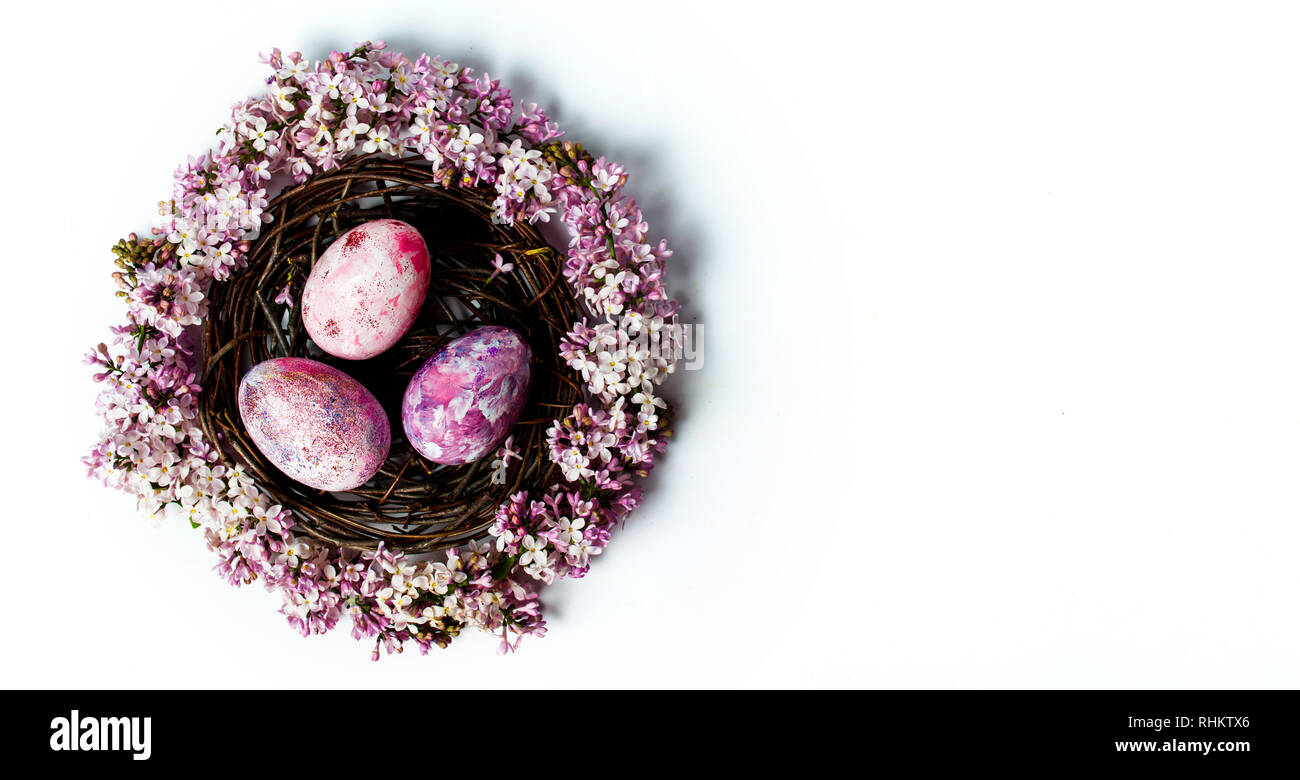 Easter eggs and colorful lilac flowers arrangement Stock Photo - Alamy