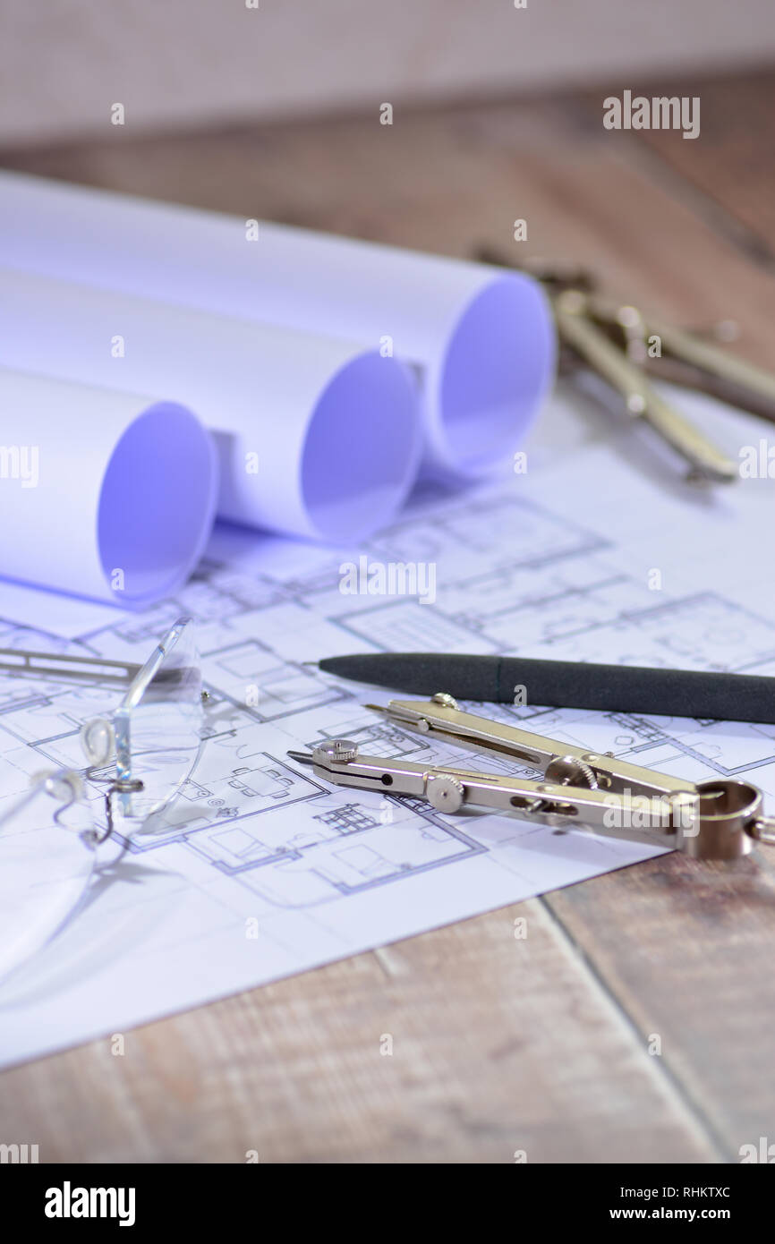 Architects drawings on a wooden table Stock Photo - Alamy