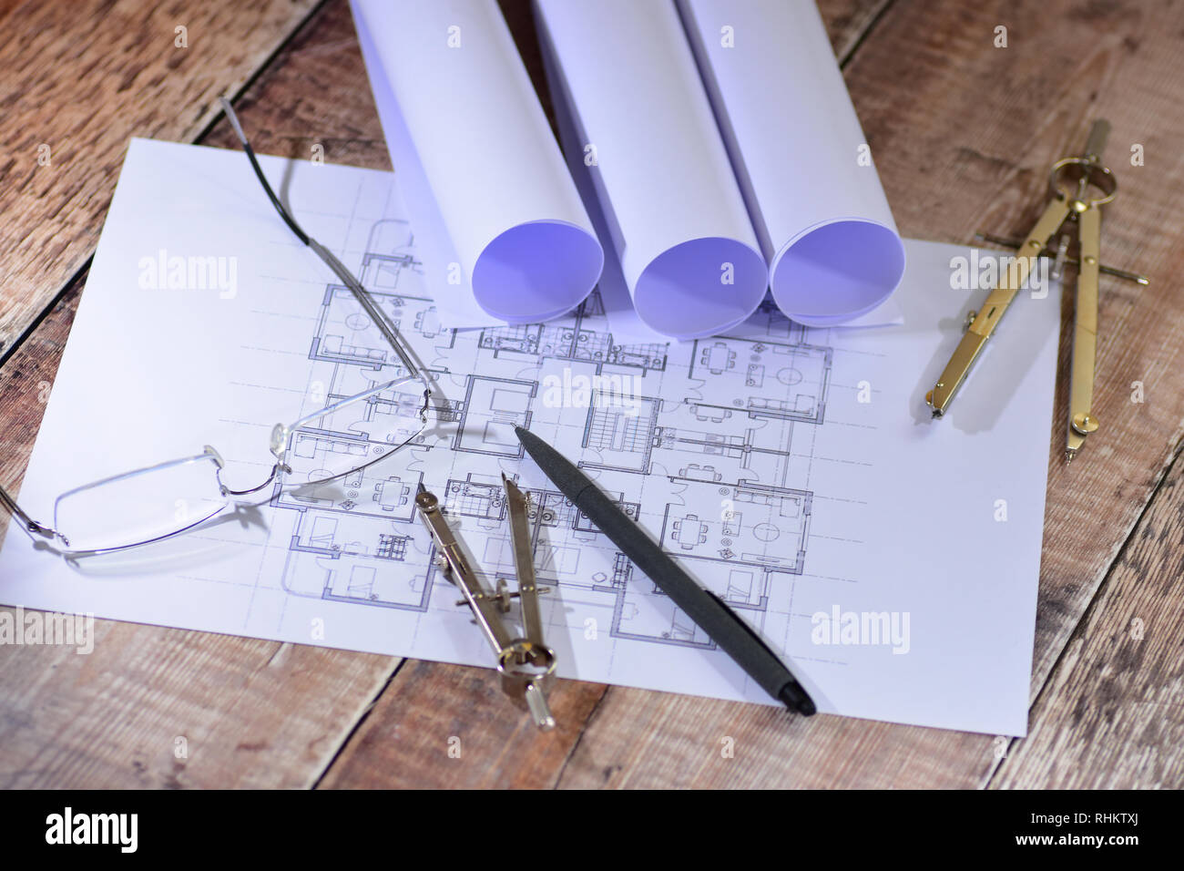 Architects drawings on a wooden table Stock Photo - Alamy