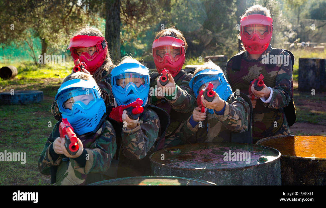 Friendly happy cheerful positive smiling group of children paintball ...