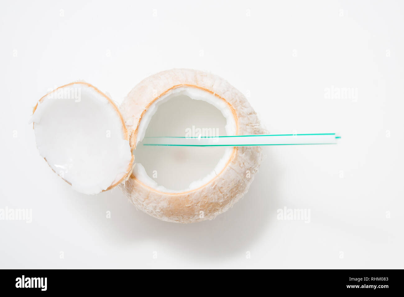 top view of coconut water with drinking straw isolated on white ...