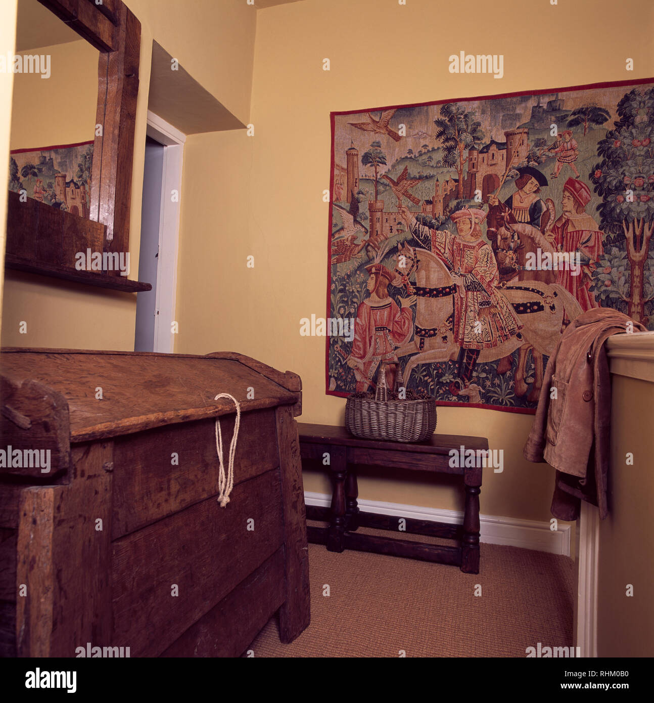 Rustic wooden medieval chest on landing with large tapestry Stock Photo ...