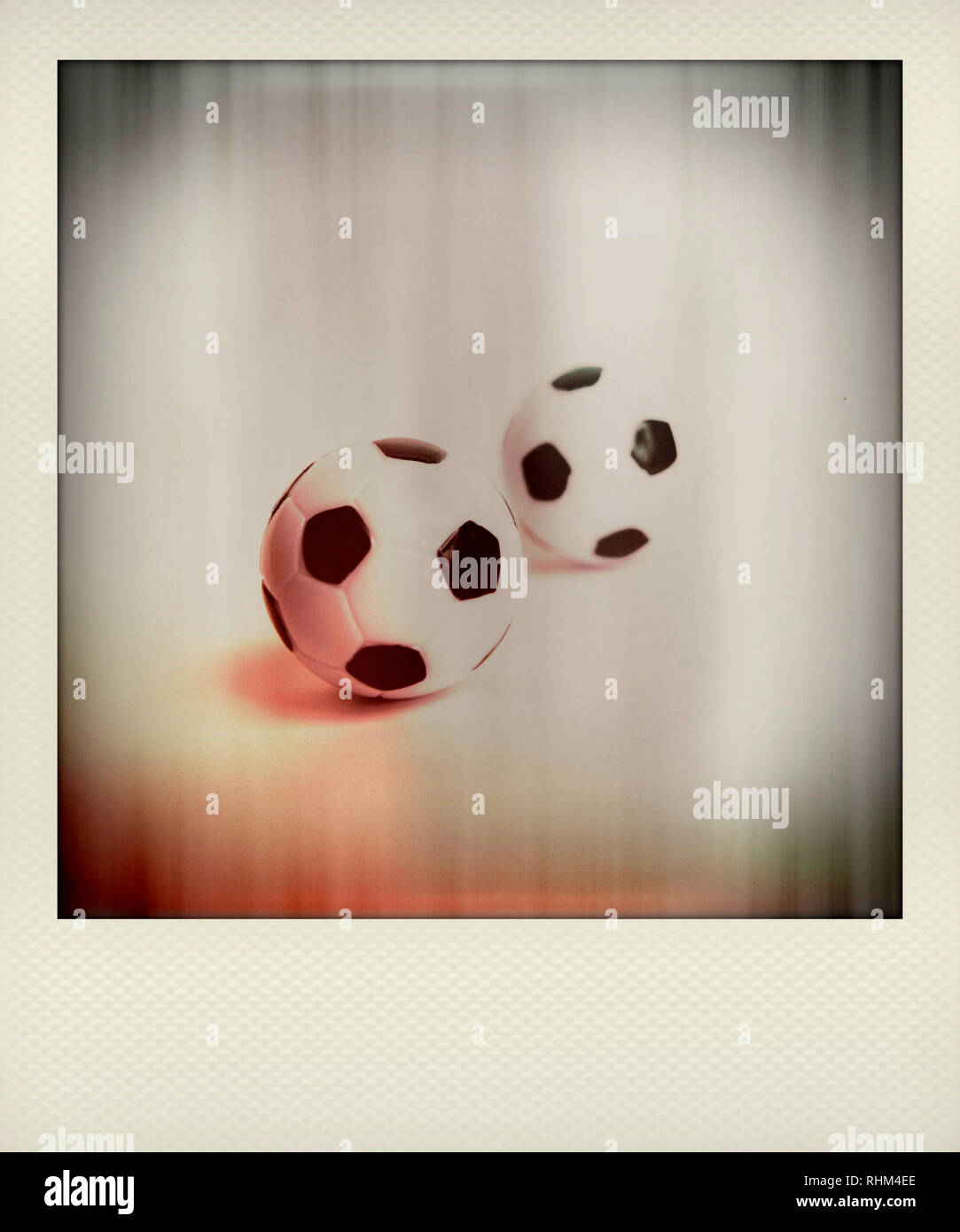 Polaroid photograph of toy soccer balls Stock Photo - Alamy