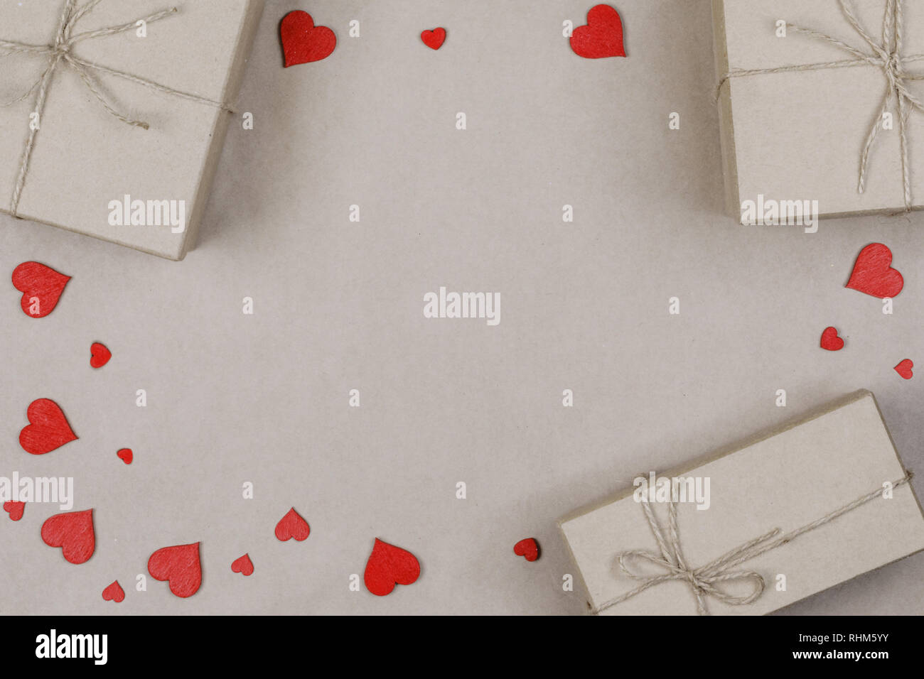 Gift boxes wrapped in brown craft paper and tied with rope with red ...