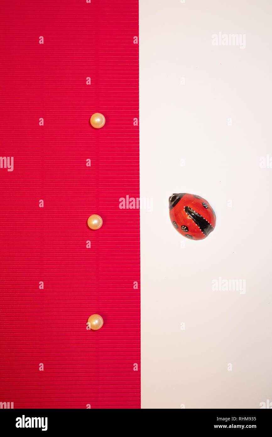 Cute background with a ladybug and pearls Stock Photo - Alamy