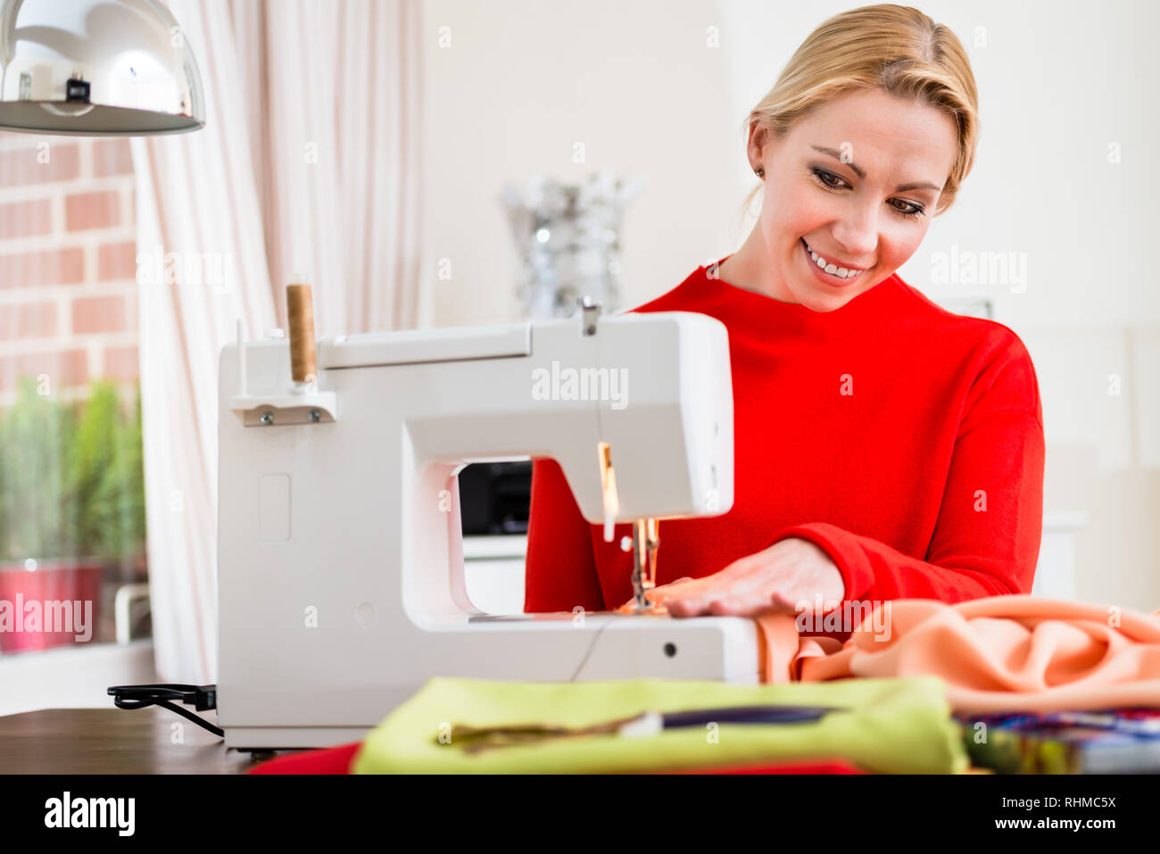 Woman smiling sewing machine hi-res stock photography and images - Alamy