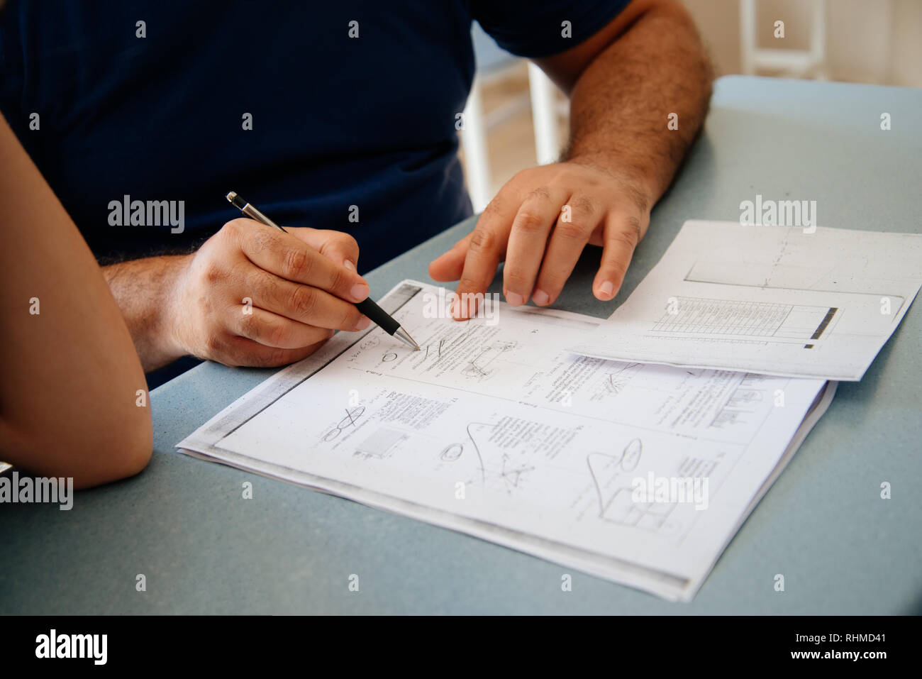Teacher teaching lesson to student with solving test exam problems ...