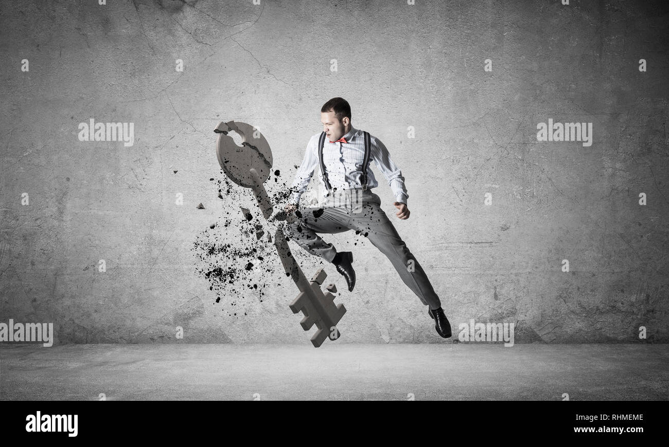 Breaking through access concept with furious man in room crashing ...