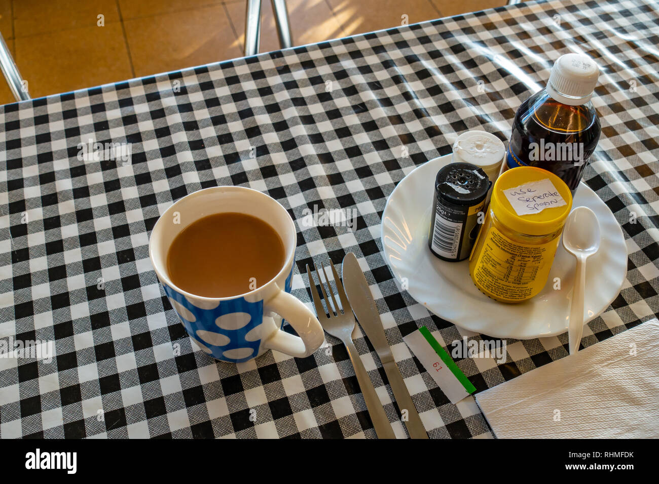 Builders mug of Tea on a plastic gingham table cloth, in a cafe in ...