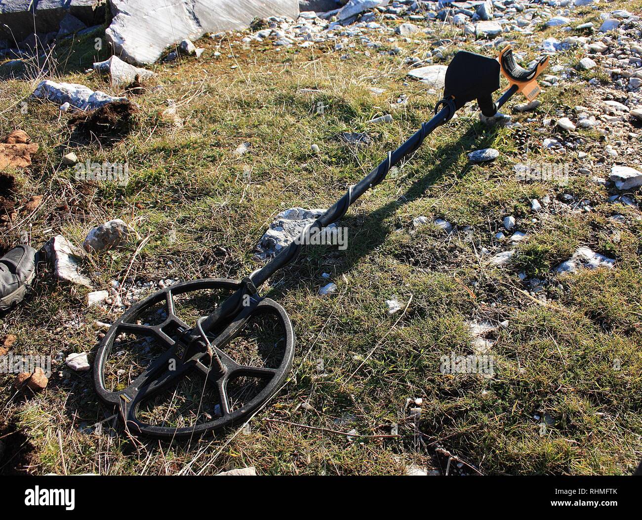 look for hidden treasures with the metal detector Stock Photo - Alamy