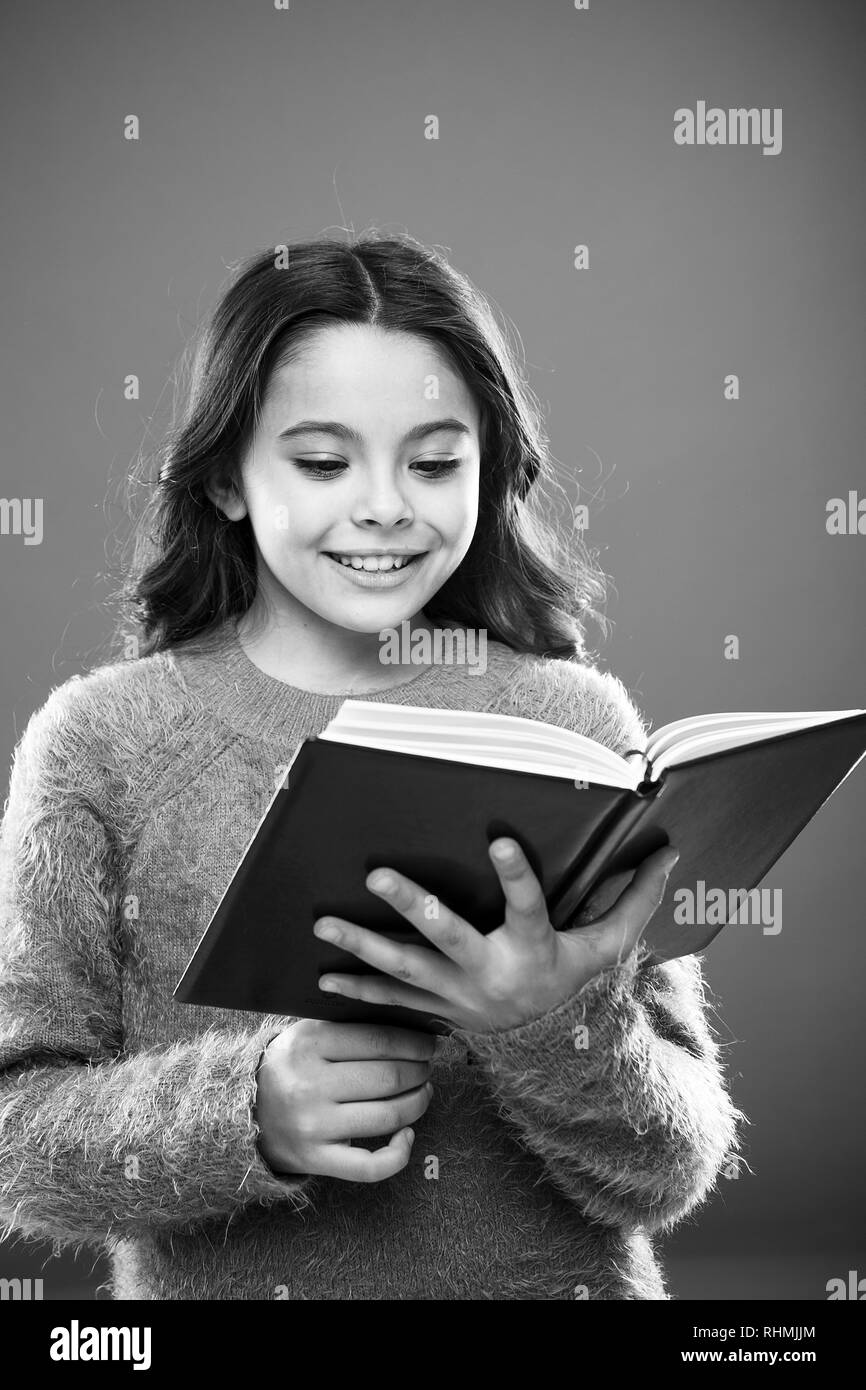 Reading practice for kids. Girl hold book read story over orange ...