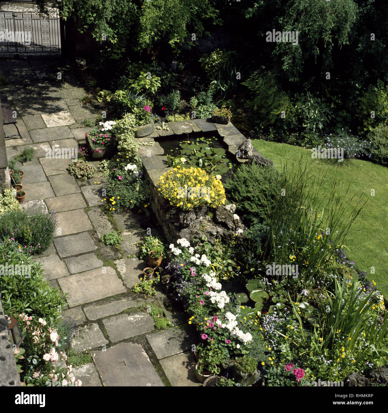 Birds-eye view of stone paving beside border and small pool Stock Photo ...