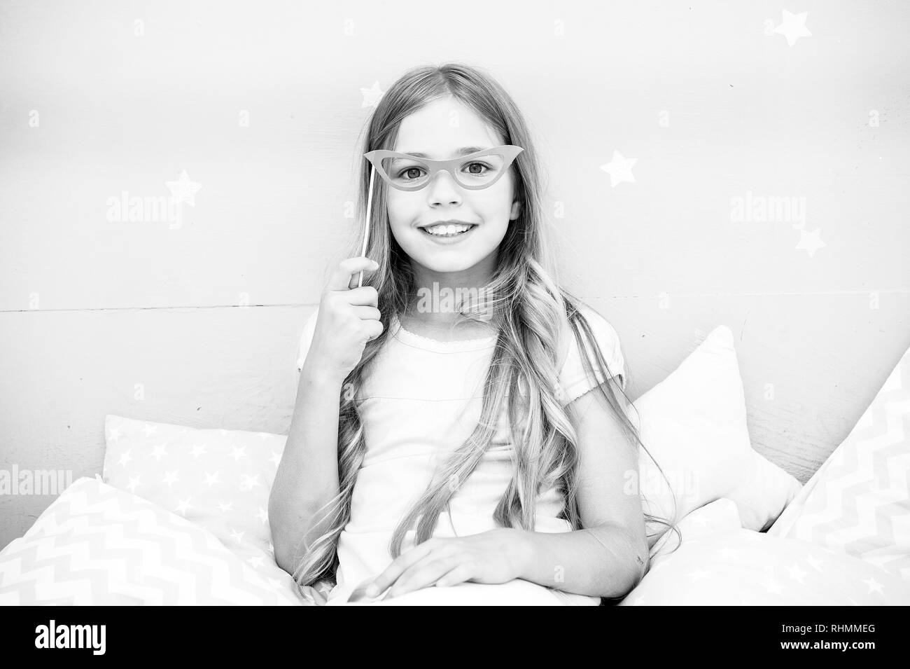 Girl long blonde hair posing with photo booth props. Pajamas party ...