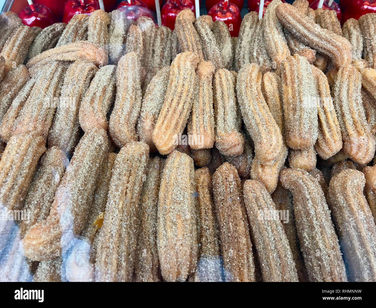 Stack of Churros with Powdered Sugar at Showcase of Bakery. Traditional ...