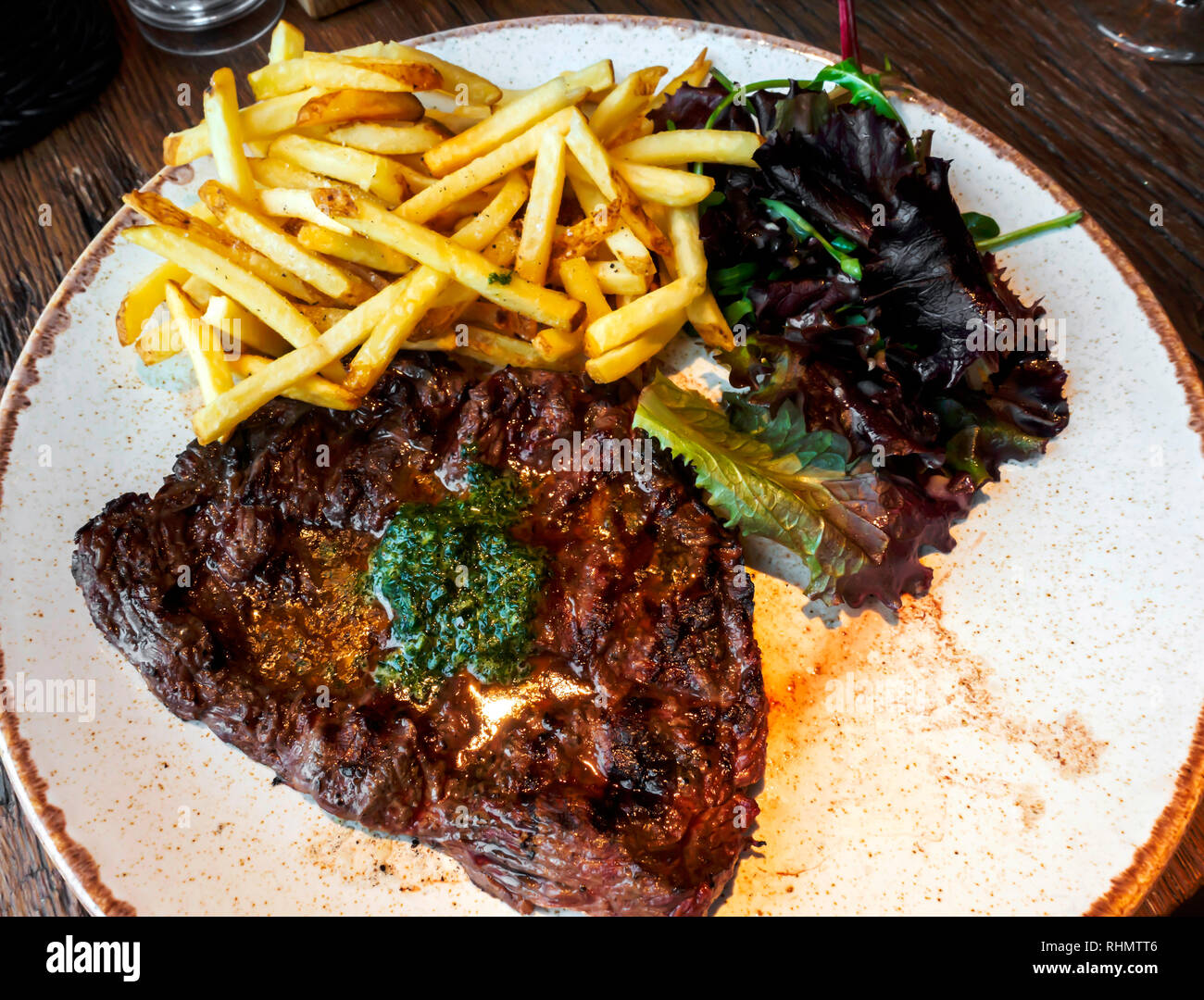 Lunchtime flattened pan-seared bavette Steak served with French fried ...