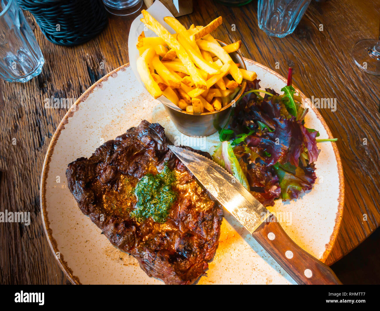 Lunchtime flattened pan-seared bavette Steak served with French fried ...