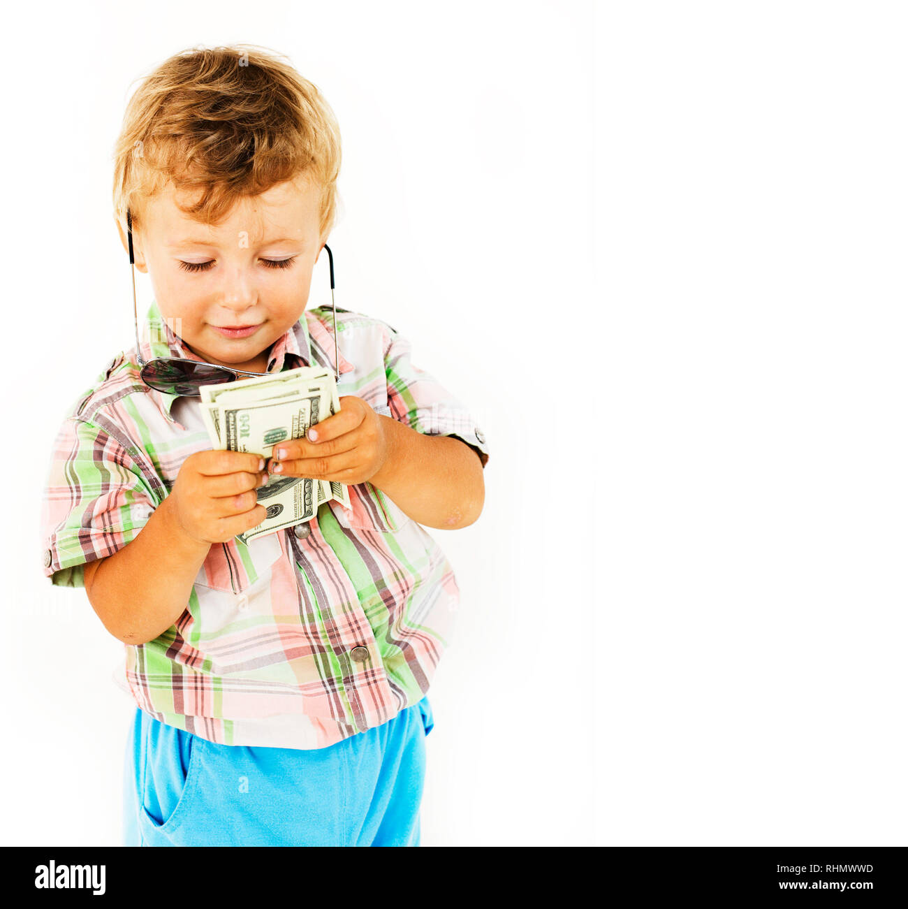 young cute boy holding lot of cash, american dollars isolated on white ...