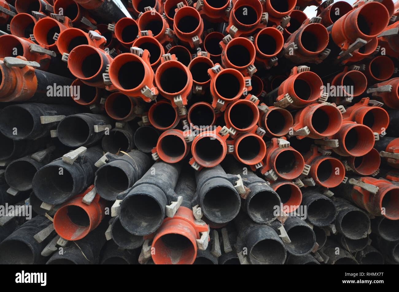 Background of plastic rubber pipes. Large Group and Stack of orange and ...