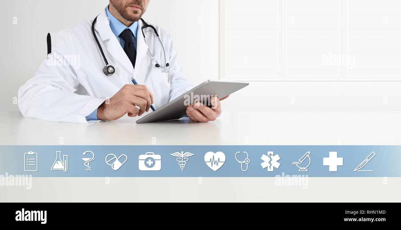 doctor at desk office write on digital tablet, with symbols and medical ...