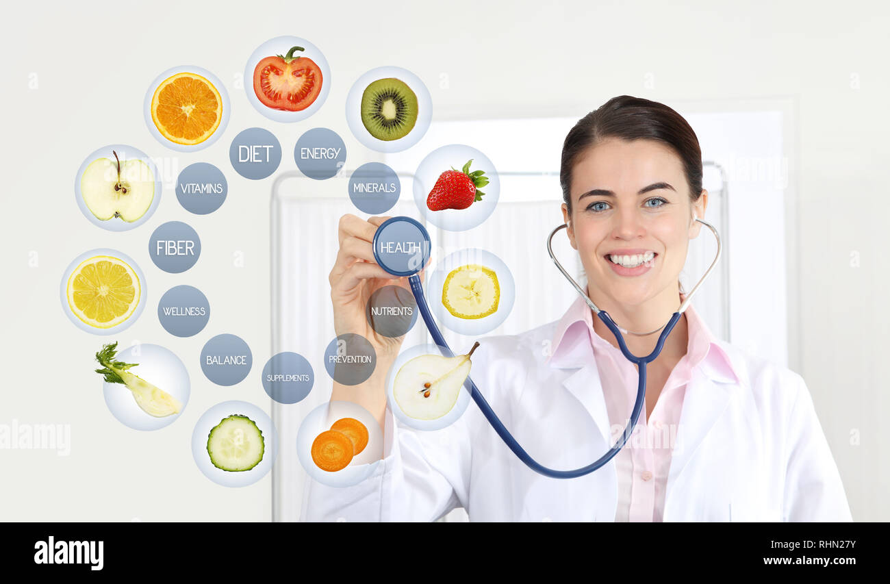 smiling nutritionist doctor with stethoscope pointing symbols fruits ...