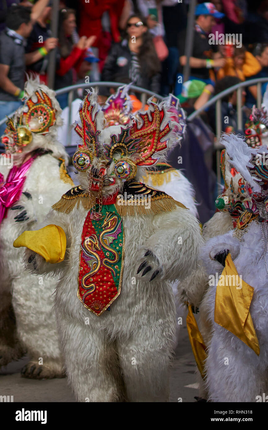 Diablada dancers in ornate bear costumes parading through the mining ...