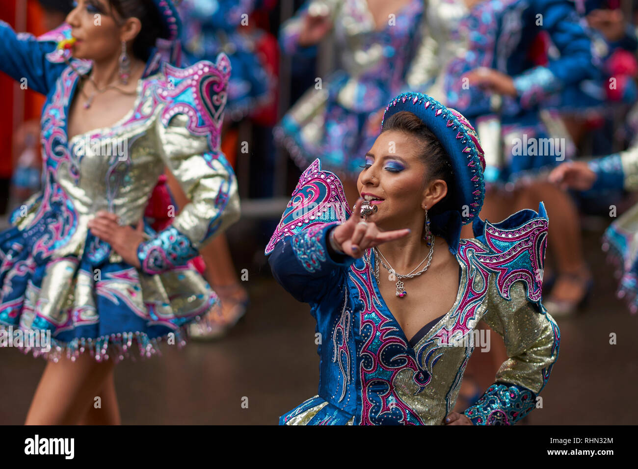 Caporales dancers in ornate costumes performing as they parade through ...
