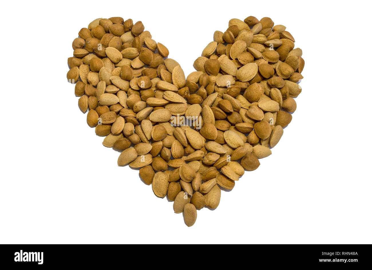 Heart made with almonds with peel isolated on white background. Concept ...