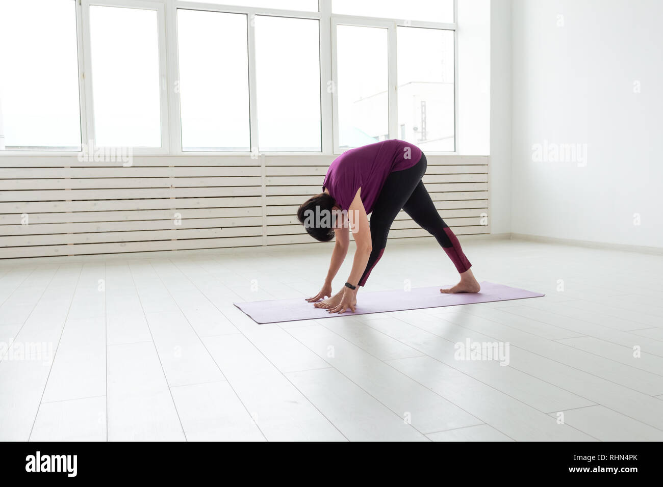 People, sport, yoga and healthcare concept - Side view of a woman doing ...
