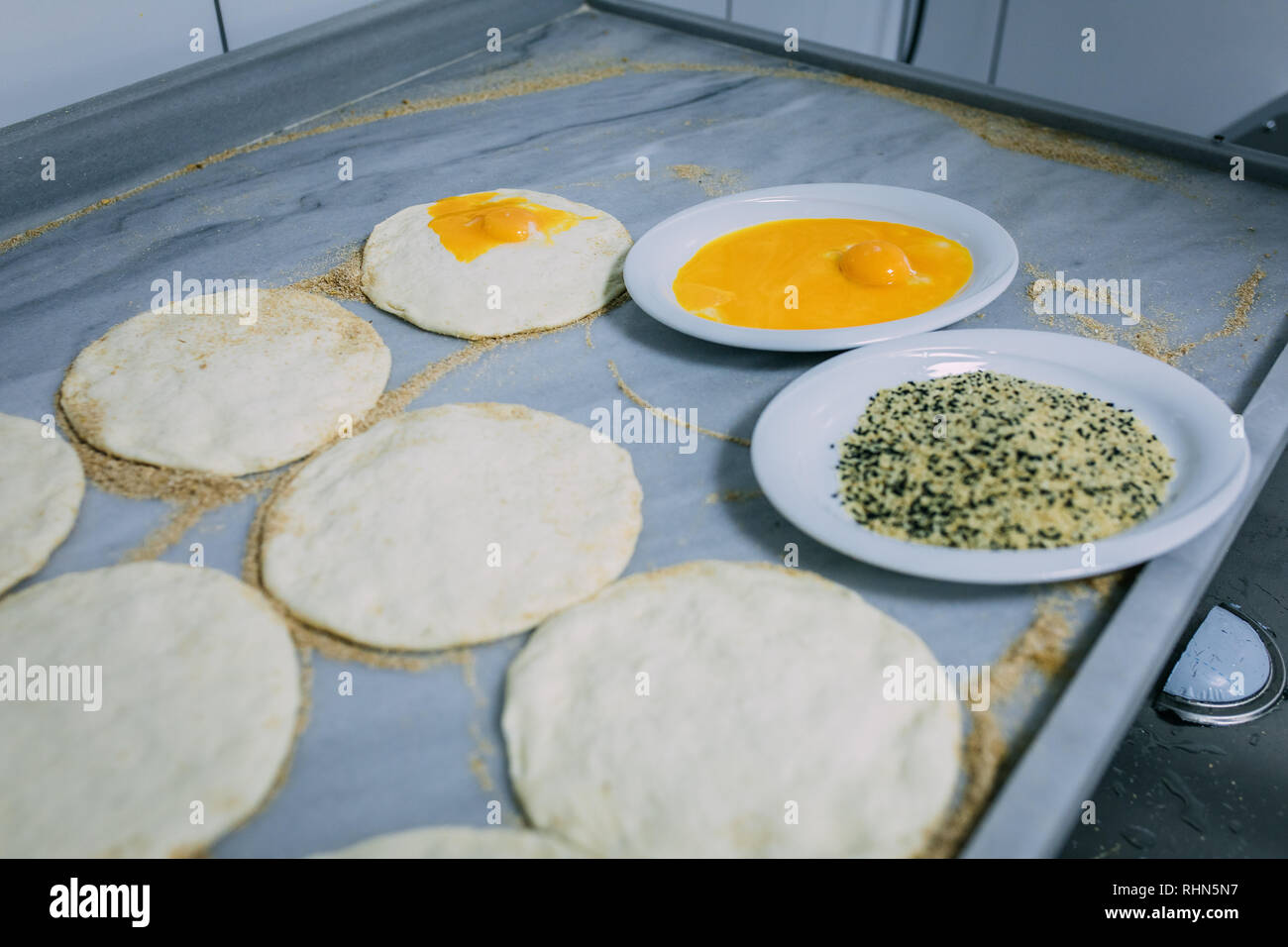 Traditional turkish Pita or pide bread doughs preparing with egg and ...