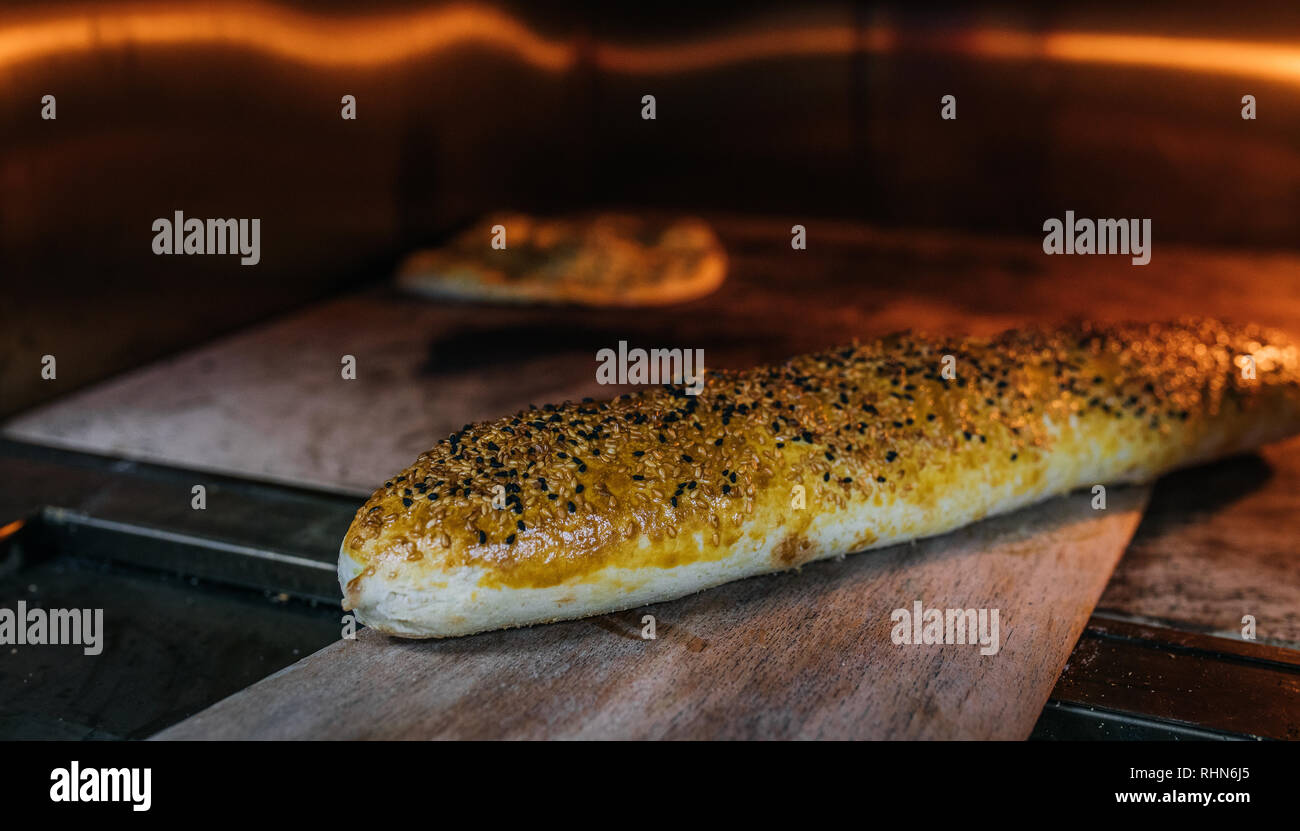 Traditional turkish Pita or pide bread in oven or stove. Bakery or ...