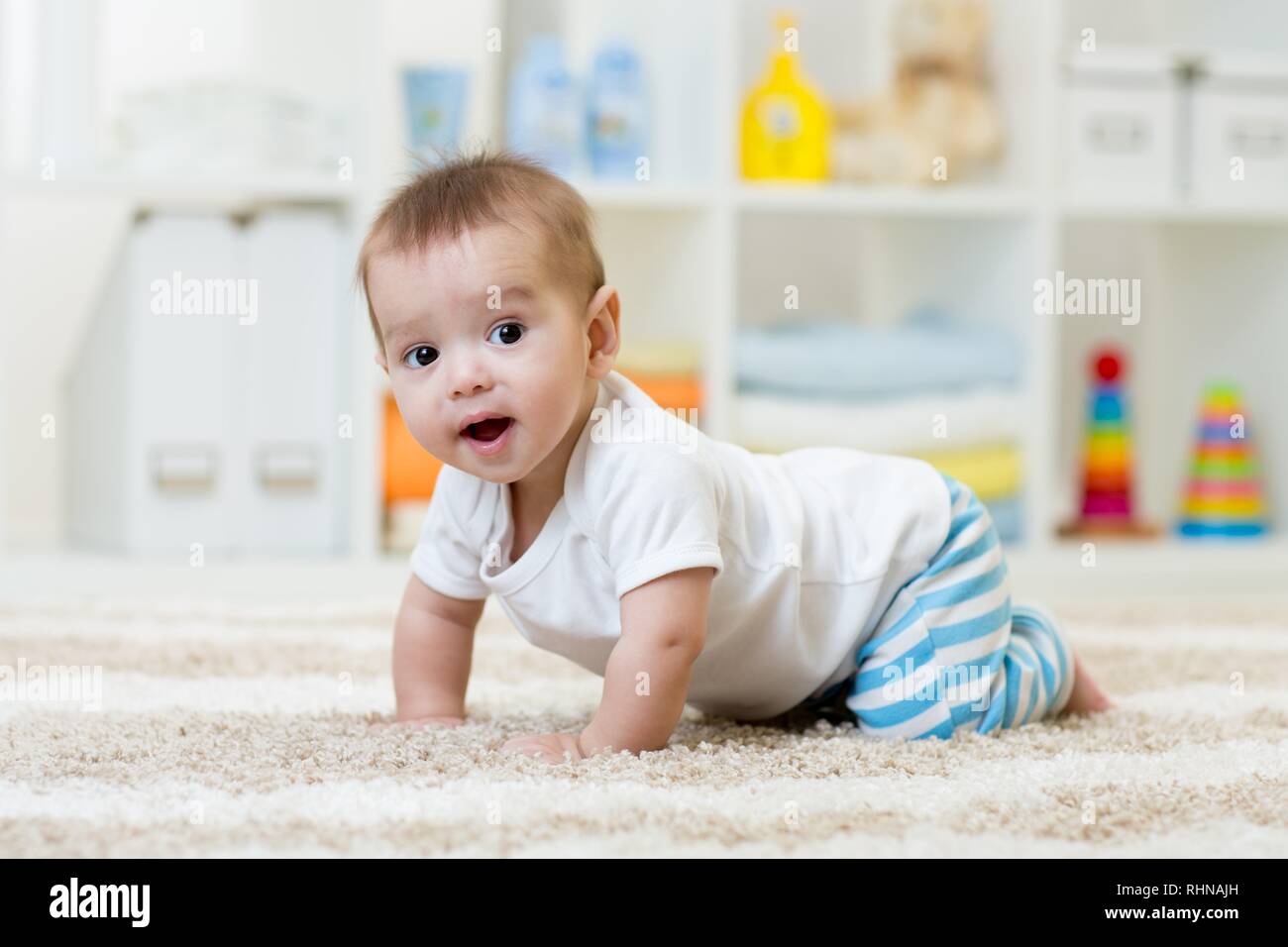 funny baby boy crawling on floor in nursery or at home Stock Photo - Alamy
