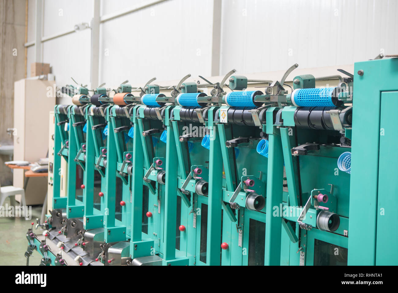 Group of bobbin thread cones on a warping machine in a textile mill ...