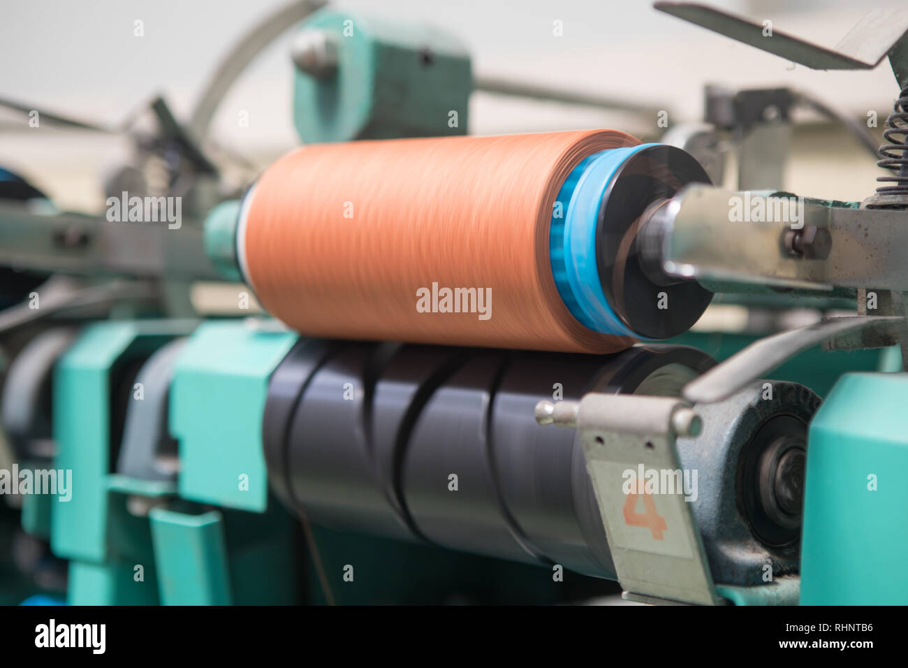Group of bobbin thread cones on a warping machine in a textile mill ...