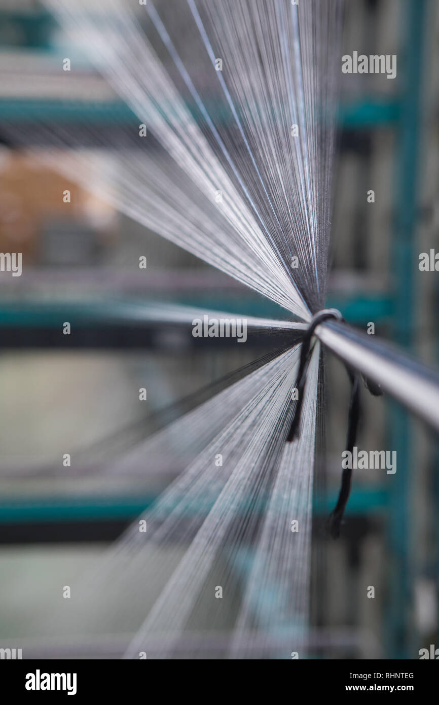 Close up macro detail of Yarn thread lines running in the weaving loom ...