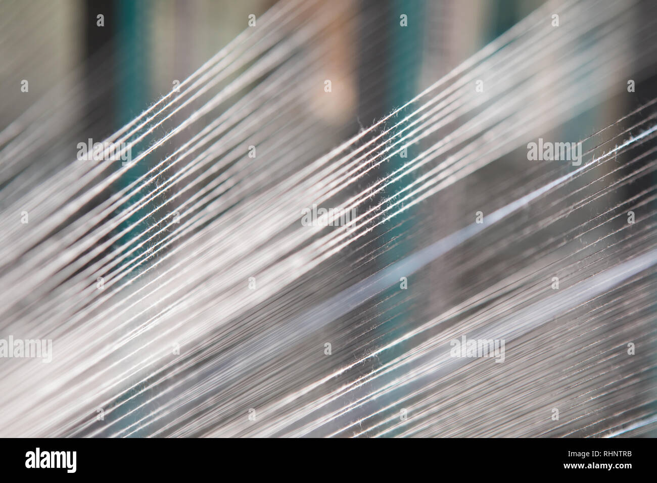 Close up macro detail of Yarn thread lines running in the weaving loom ...