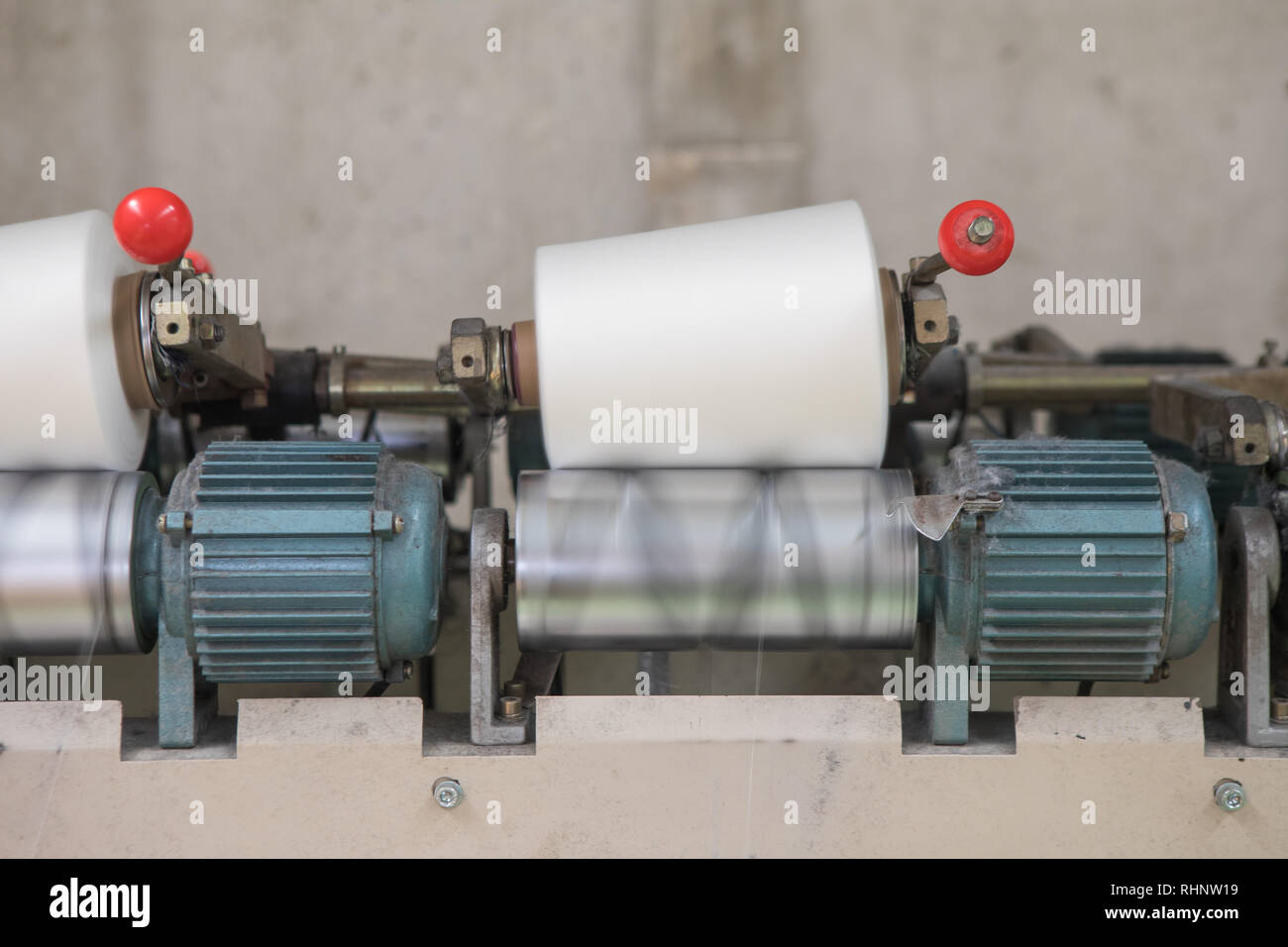 Group of bobbin thread cones on a warping machine in a textile mill ...