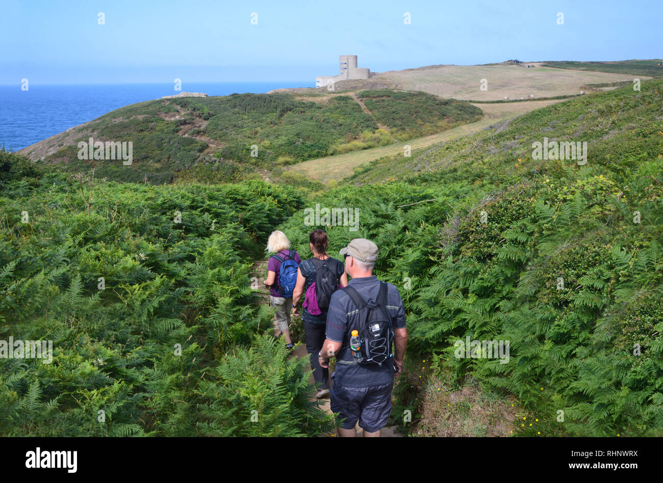 Three Hikers Walking on the Coastal Footpath to the WW2 German ...
