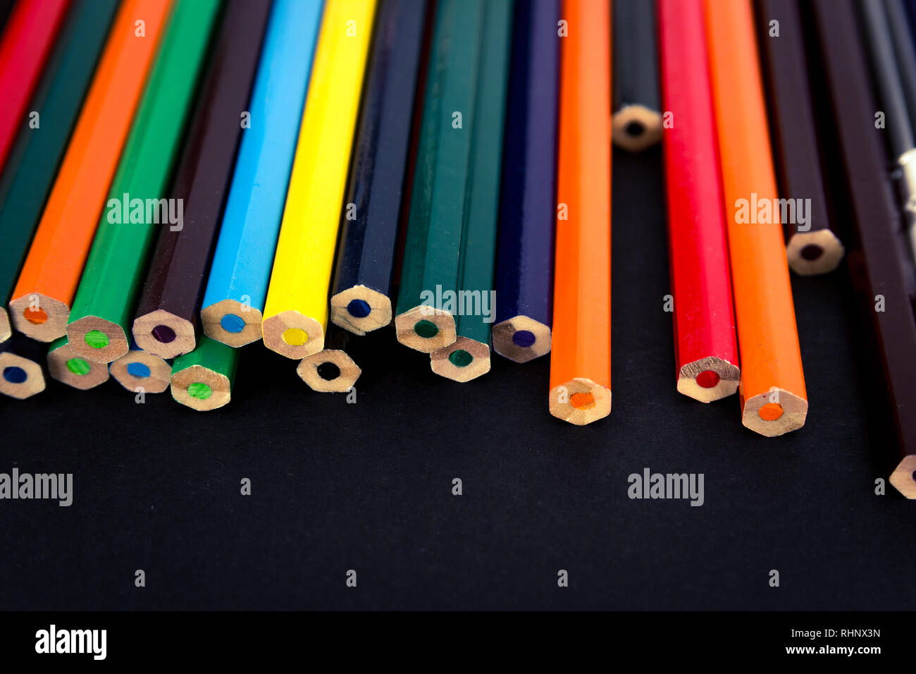 Background from colored pencils on a black surface Stock Photo - Alamy