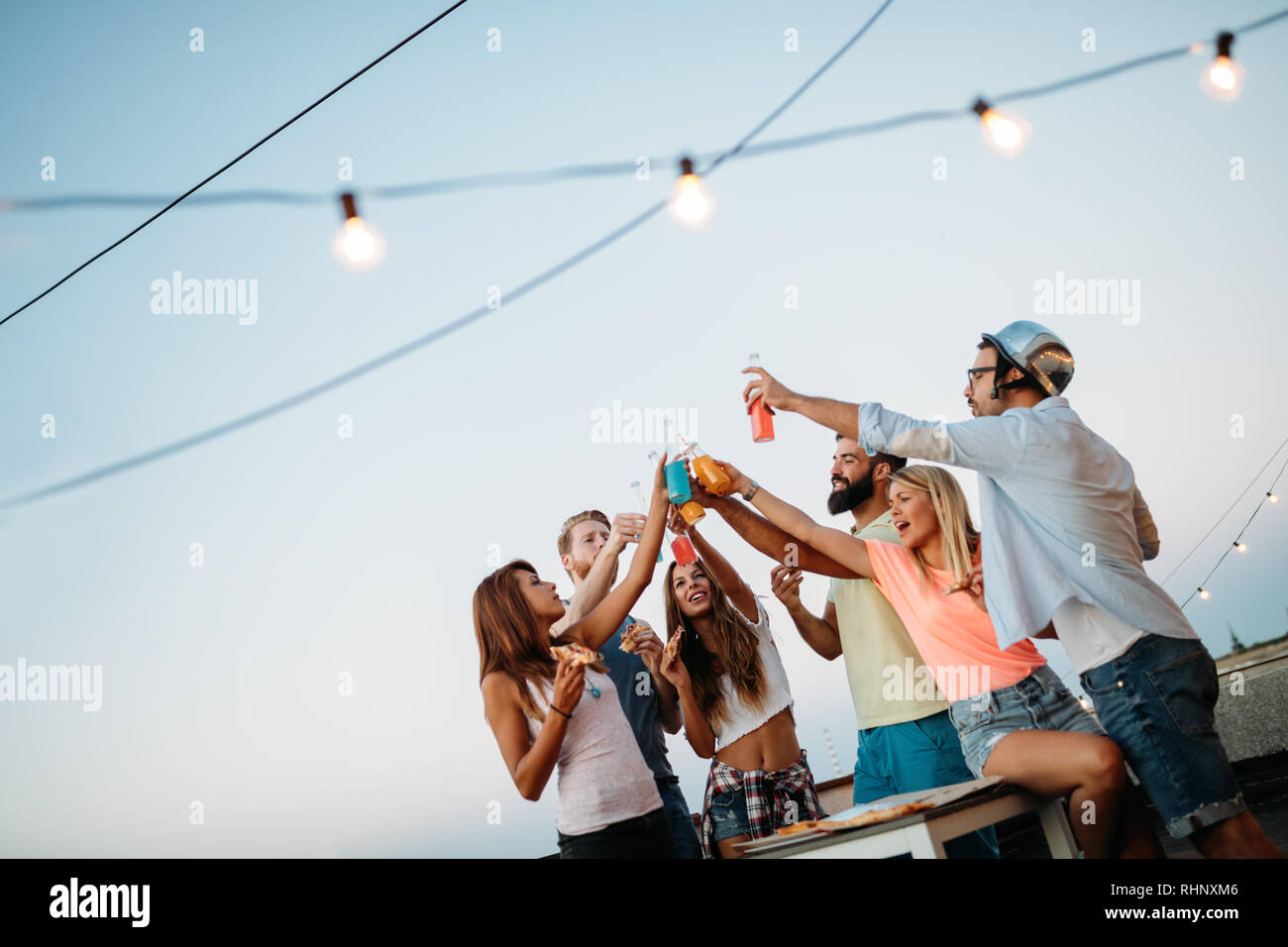 Group of happy friends having party on rooftop Stock Photo - Alamy
