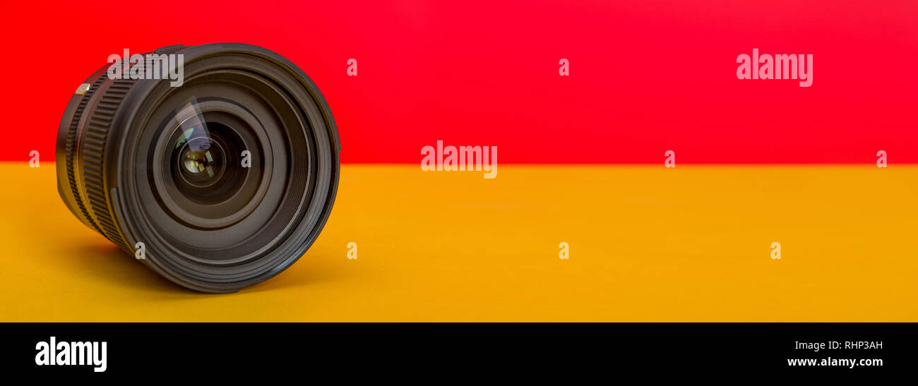 Professional Camera Lens on red and yellow background template Stock ...