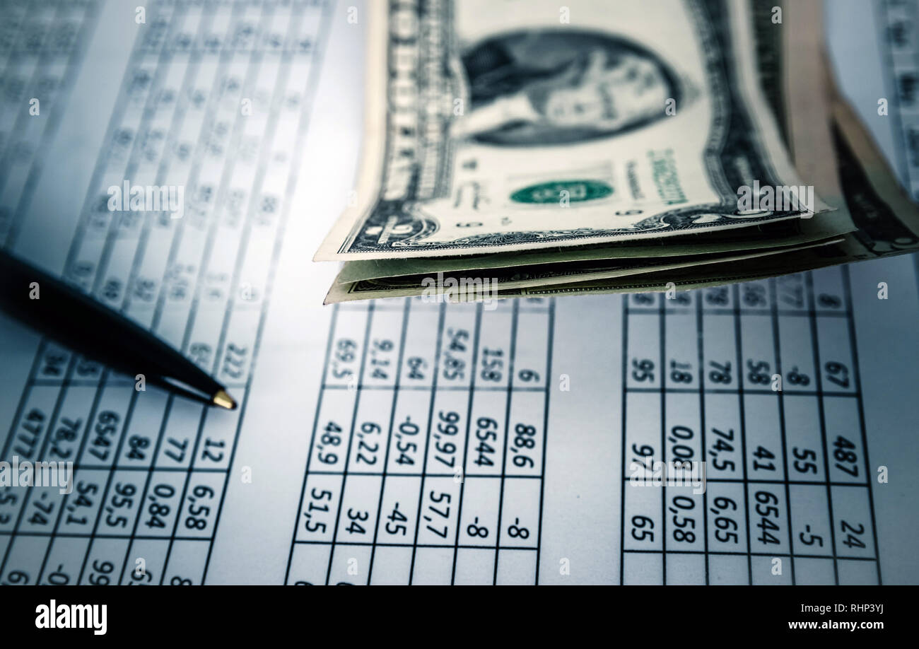 Money and pen, piece of paper with numbers, business concept. American ...