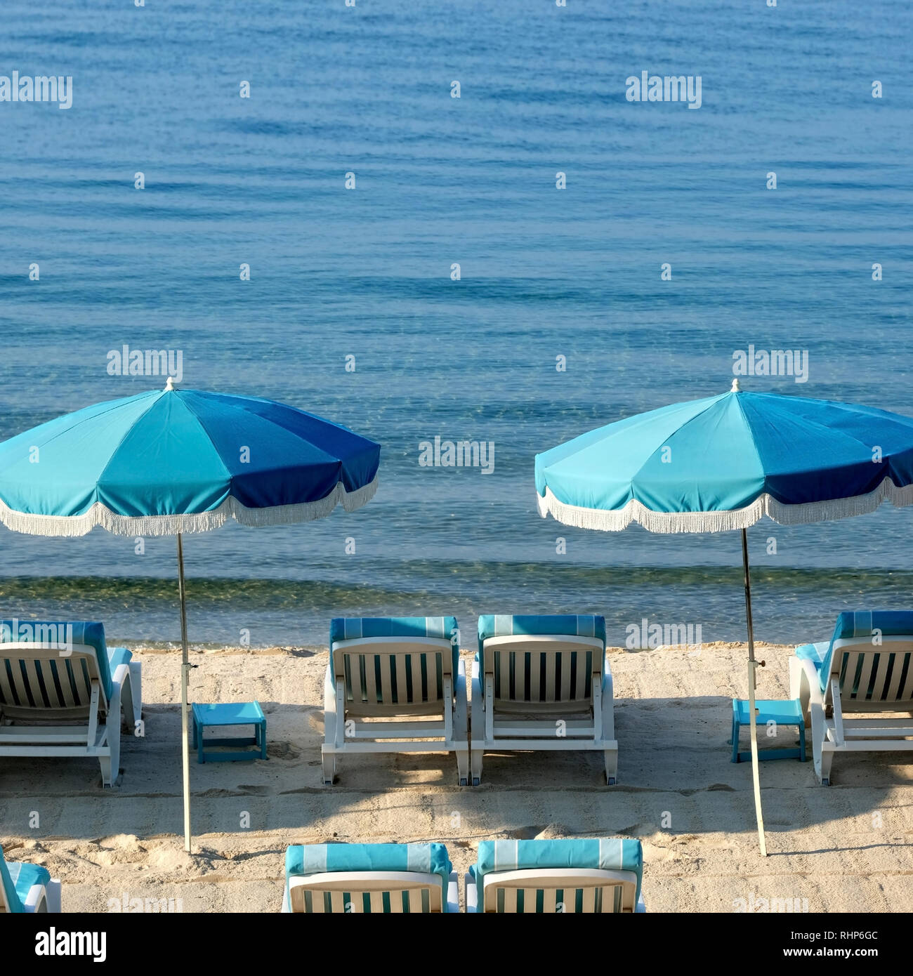 Mediterranean beach umbrella chairs relaxing Stock Photo - Alamy