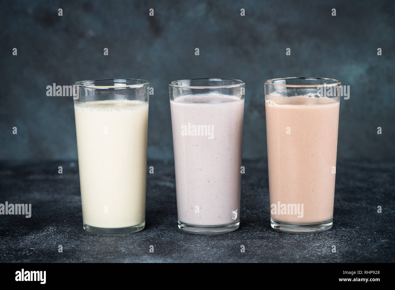 Protein cocktails on black. Vanilla, berry and chocolate protein shakes ...