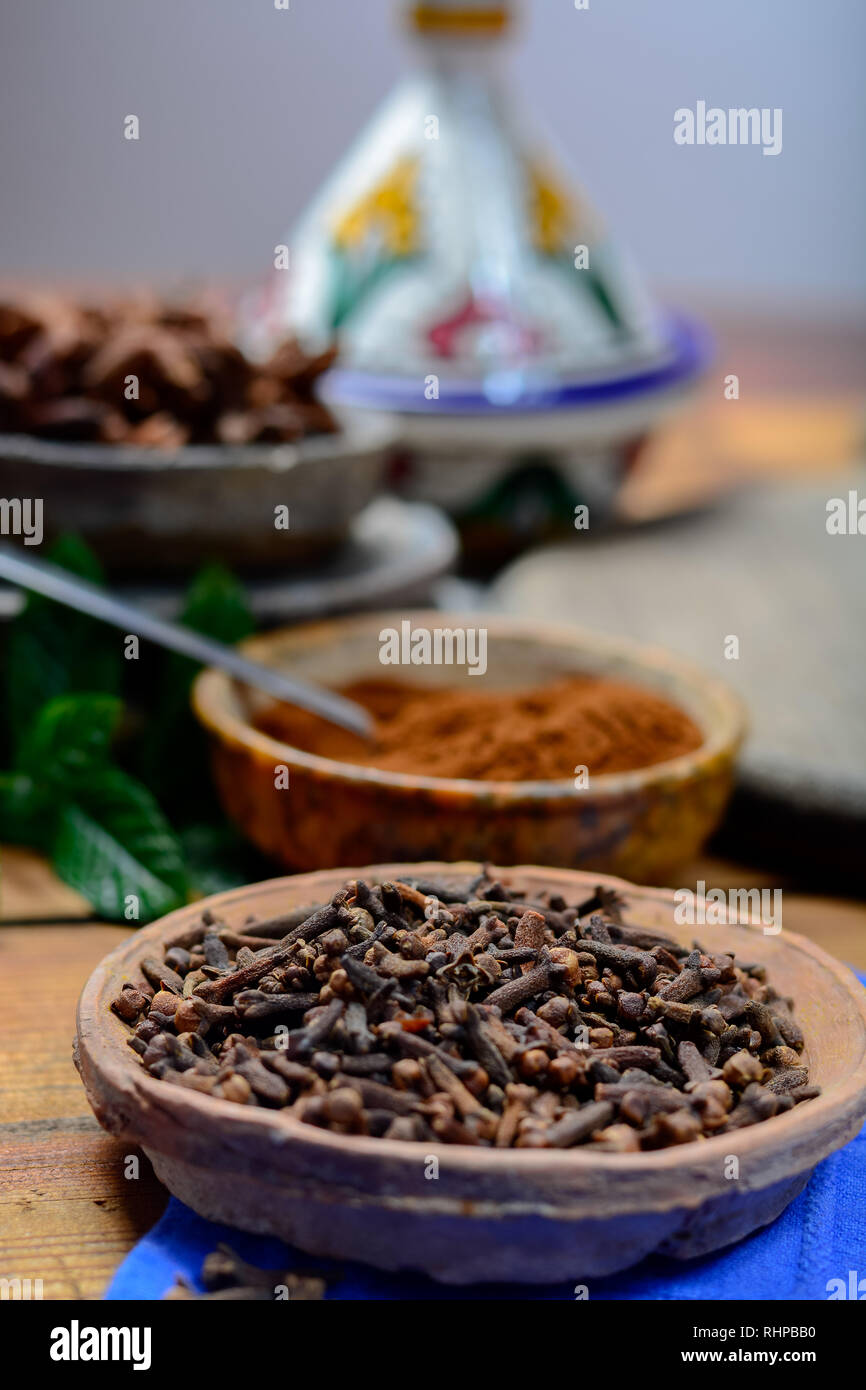 Bowls with dried clove buds and cloves powder, used for cooking and ...