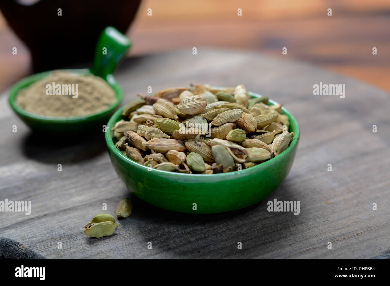 Bowl with cardamom pots and cardamom powder, used for cooking and ...