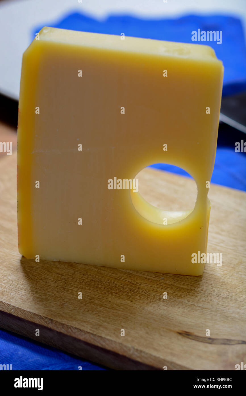 Block of Swiss Emmental or Emmentaler medium-hard cheese with round ...